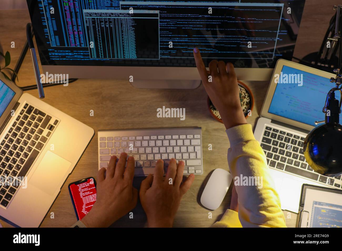 Programmers working in office at night, top view Stock Photo - Alamy