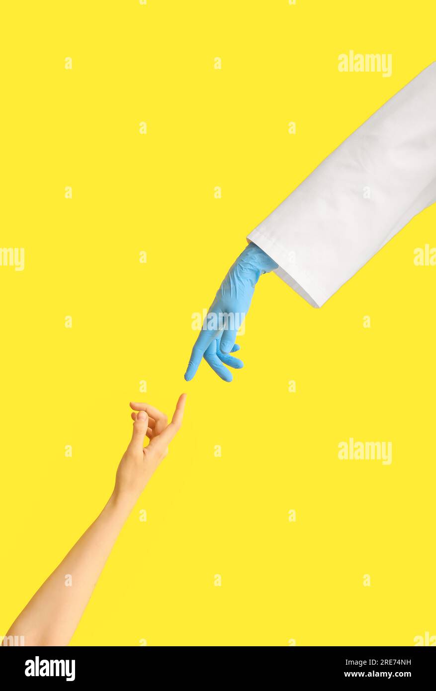 Patient's and doctor's hands reaching each other on yellow background ...