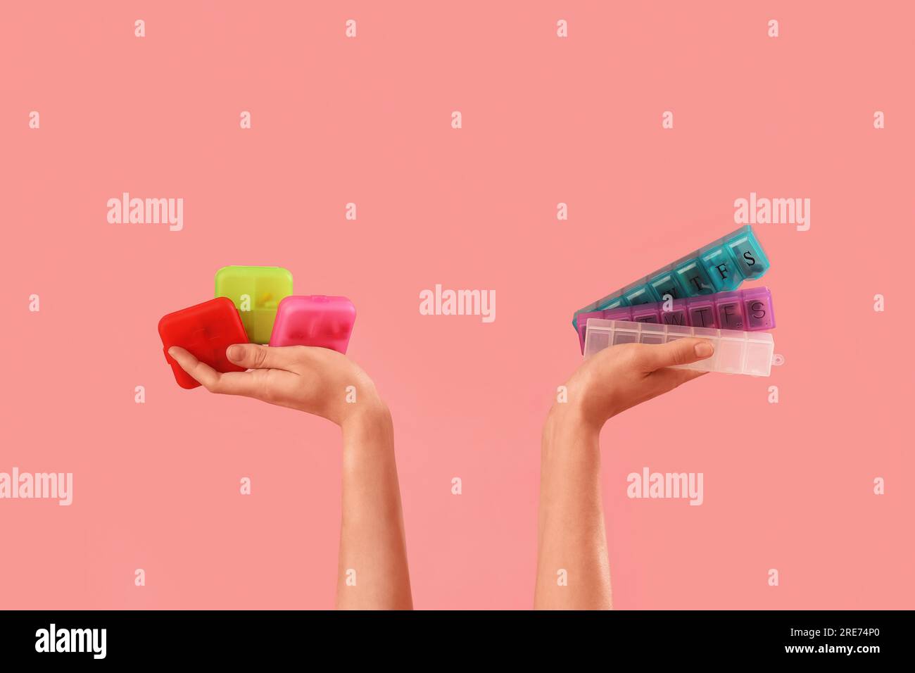 Female hands with different pill boxes on pink background Stock Photo ...