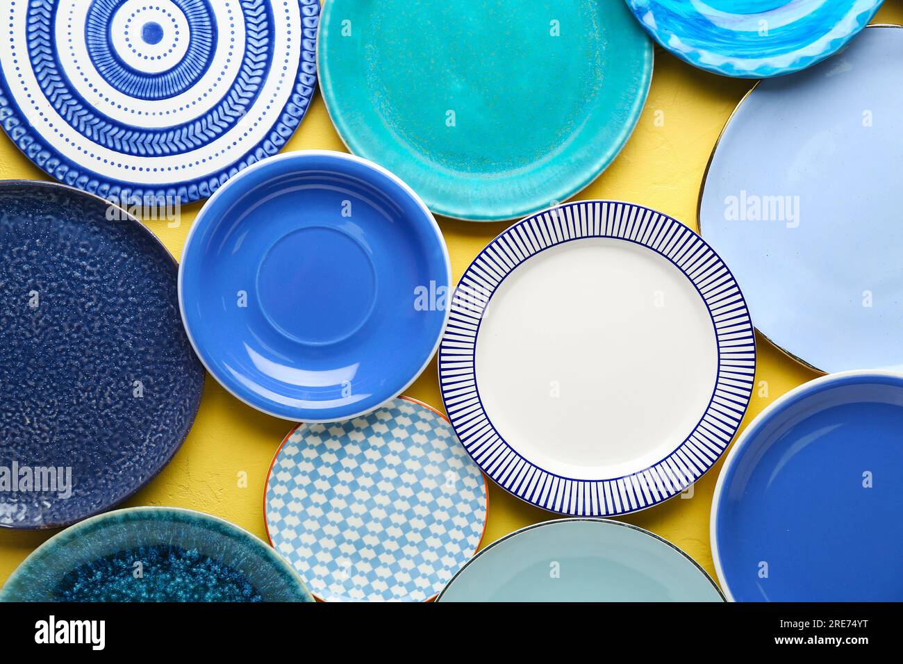 Set of colorful clean plates on yellow background Stock Photo - Alamy