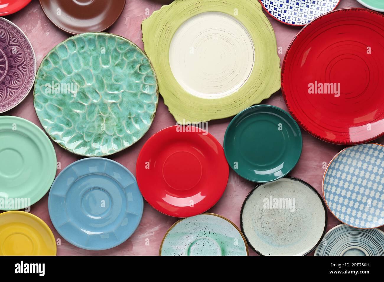 Set of colorful clean plates on pink background Stock Photo - Alamy