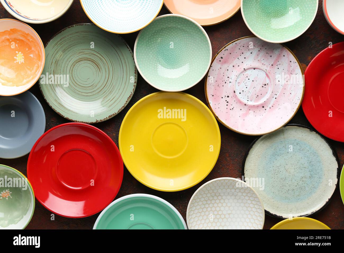Set of colorful clean plates on brown background Stock Photo - Alamy