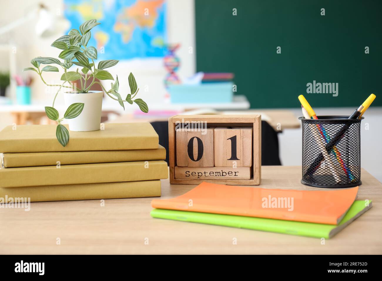 Calendar with different stationery on desk in classroom Stock Photo - Alamy