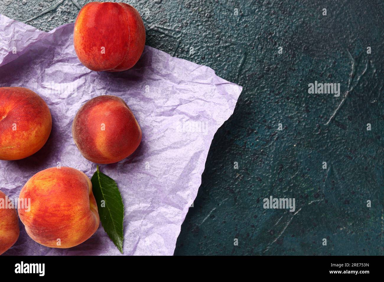 Baking paper with sweet peaches on dark background Stock Photo - Alamy