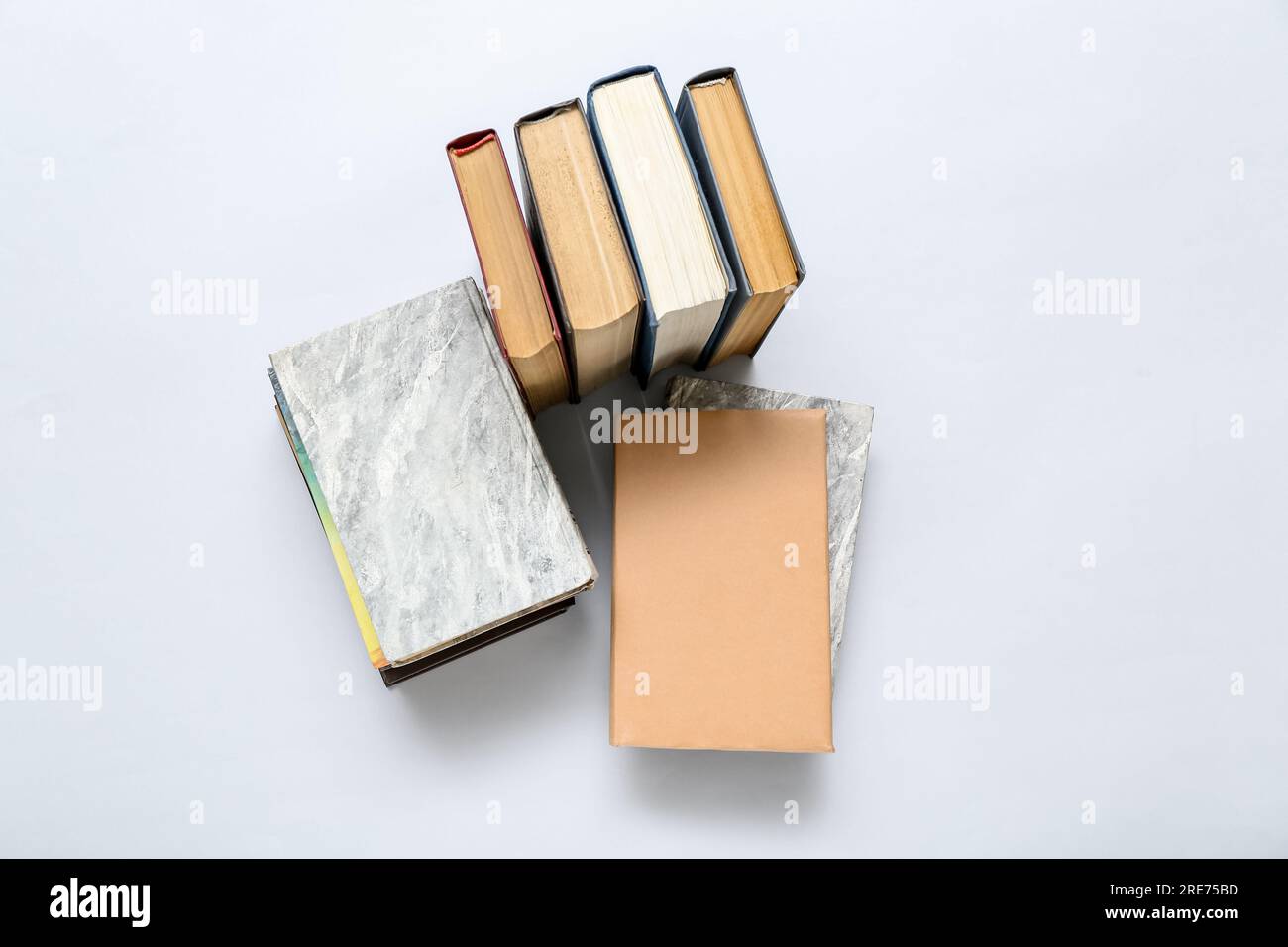 Stack of books on grey background Stock Photo - Alamy