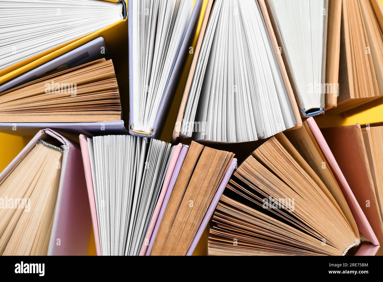 Many half open books as background Stock Photo - Alamy