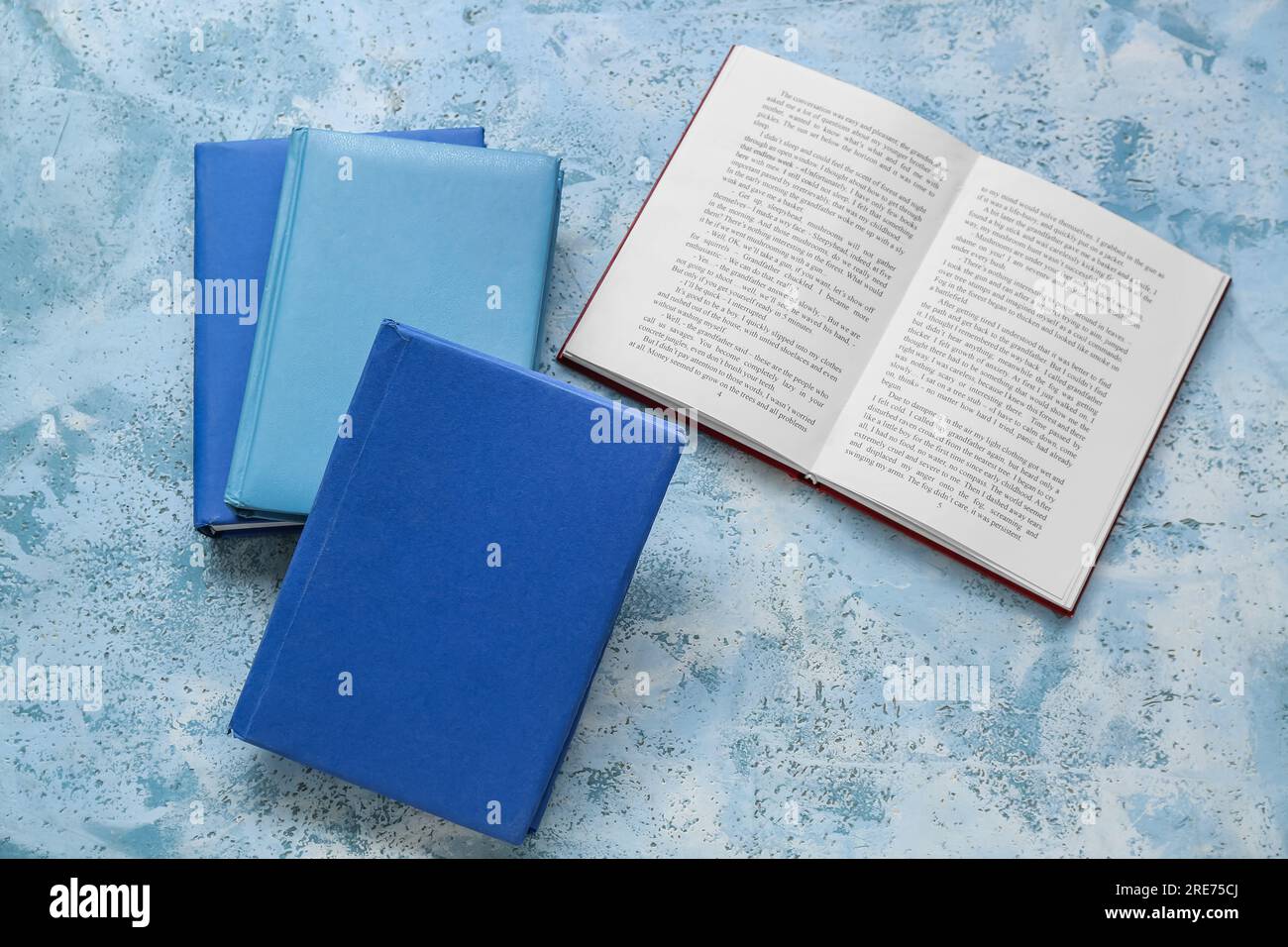 Open book on light blue table Stock Photo - Alamy