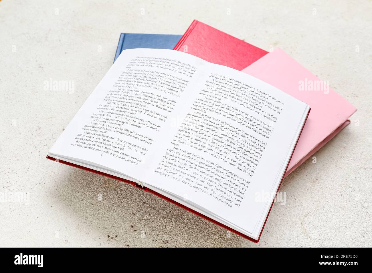 Open and closed books on white table Stock Photo - Alamy
