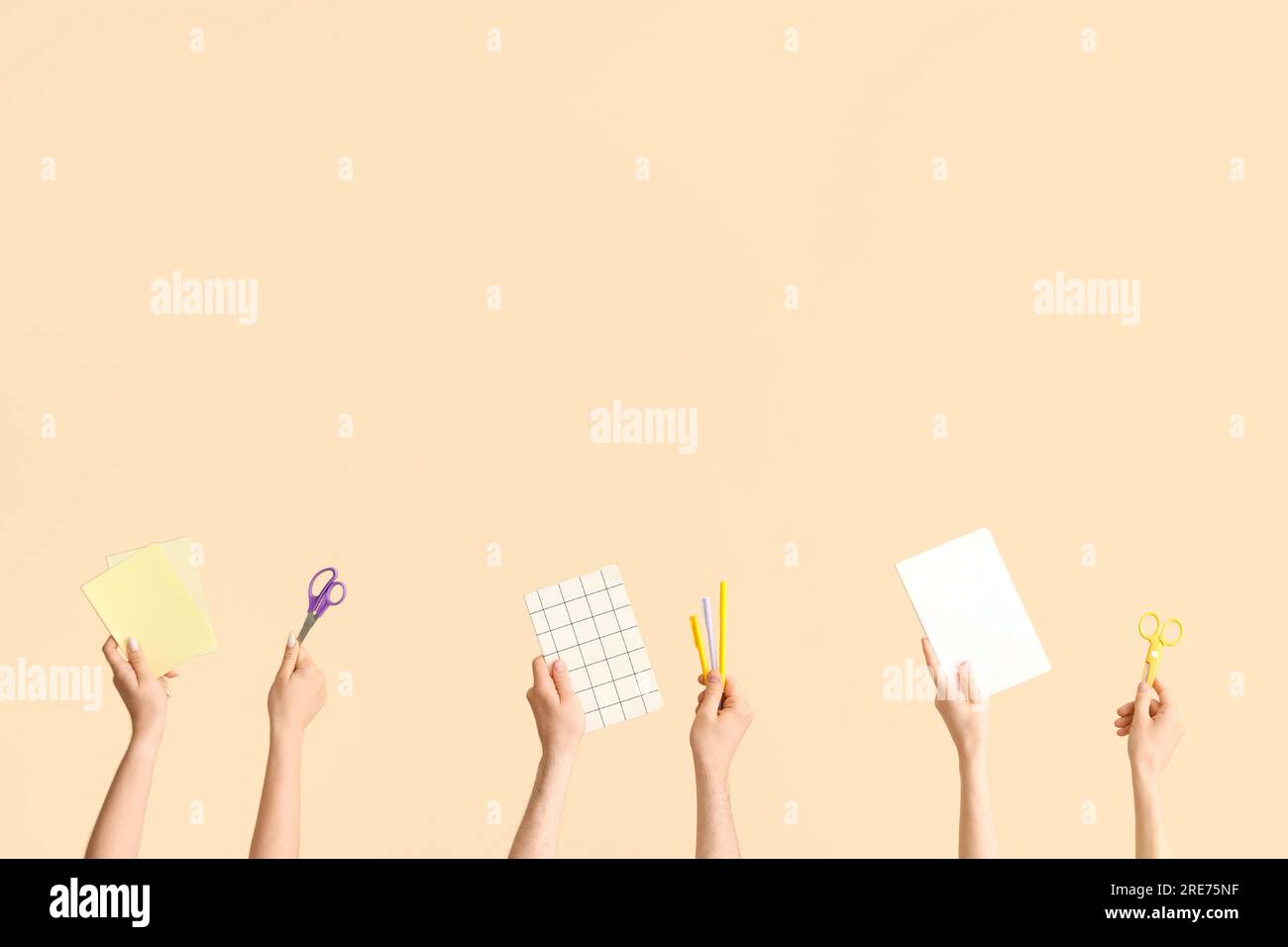 Hands with school supplies on beige background Stock Photo - Alamy