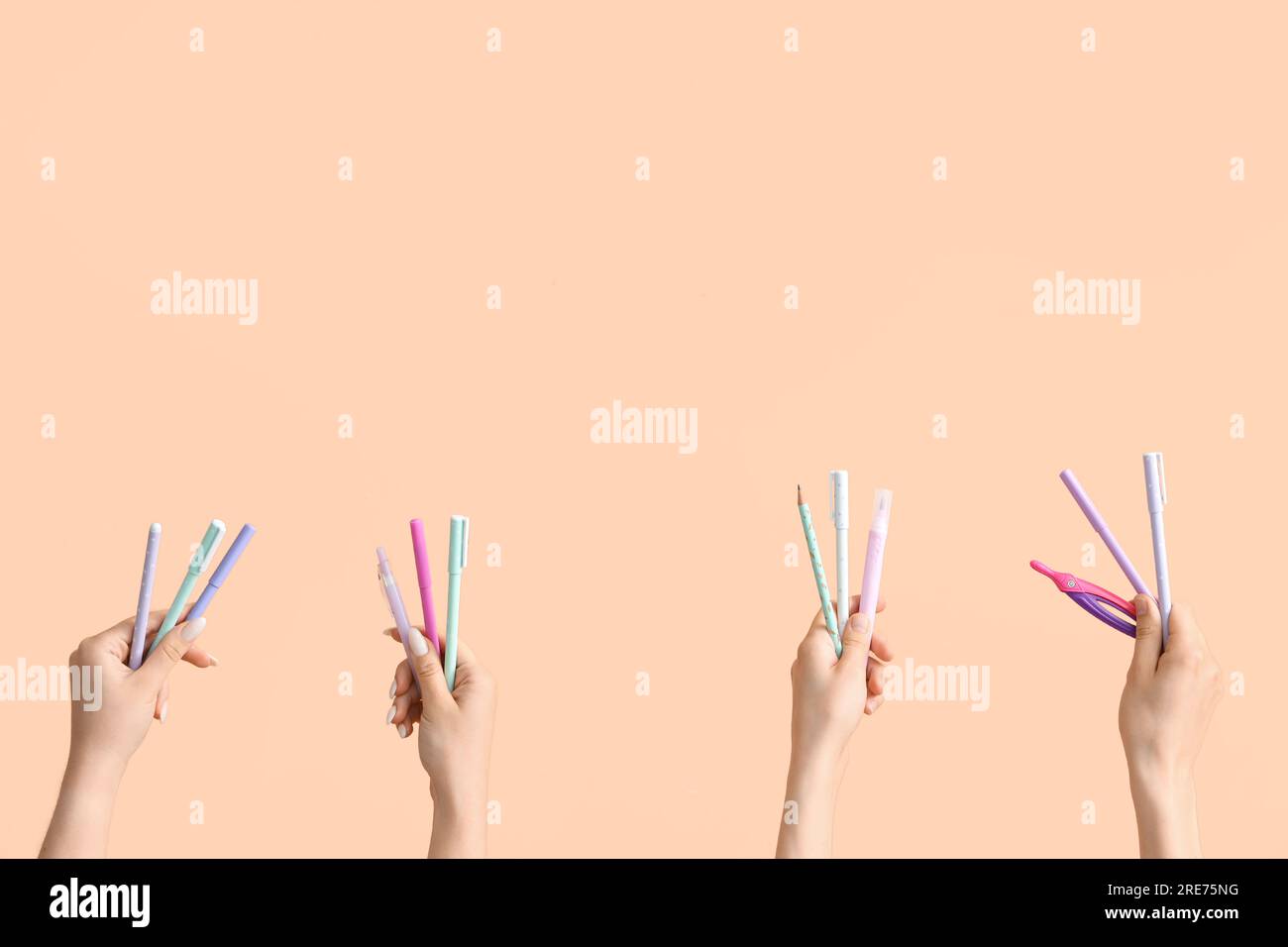 Female hands with school supplies on beige background Stock Photo - Alamy