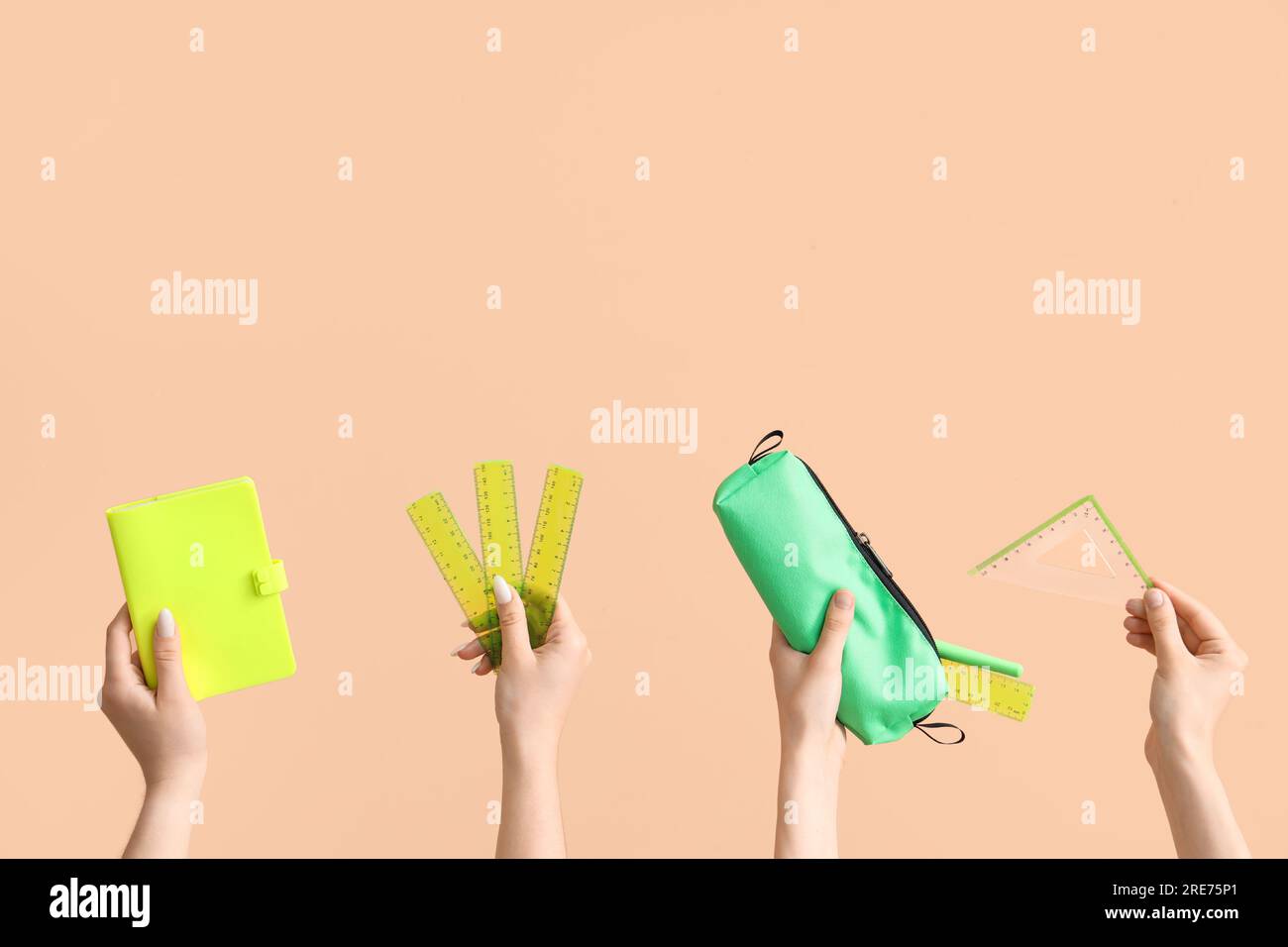 Female hands with school supplies on beige background Stock Photo - Alamy