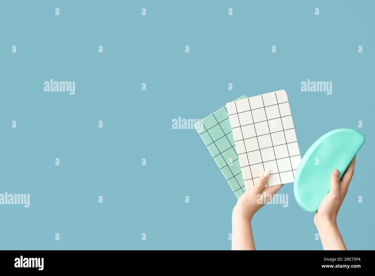 Female hands with school supplies on blue background Stock Photo - Alamy