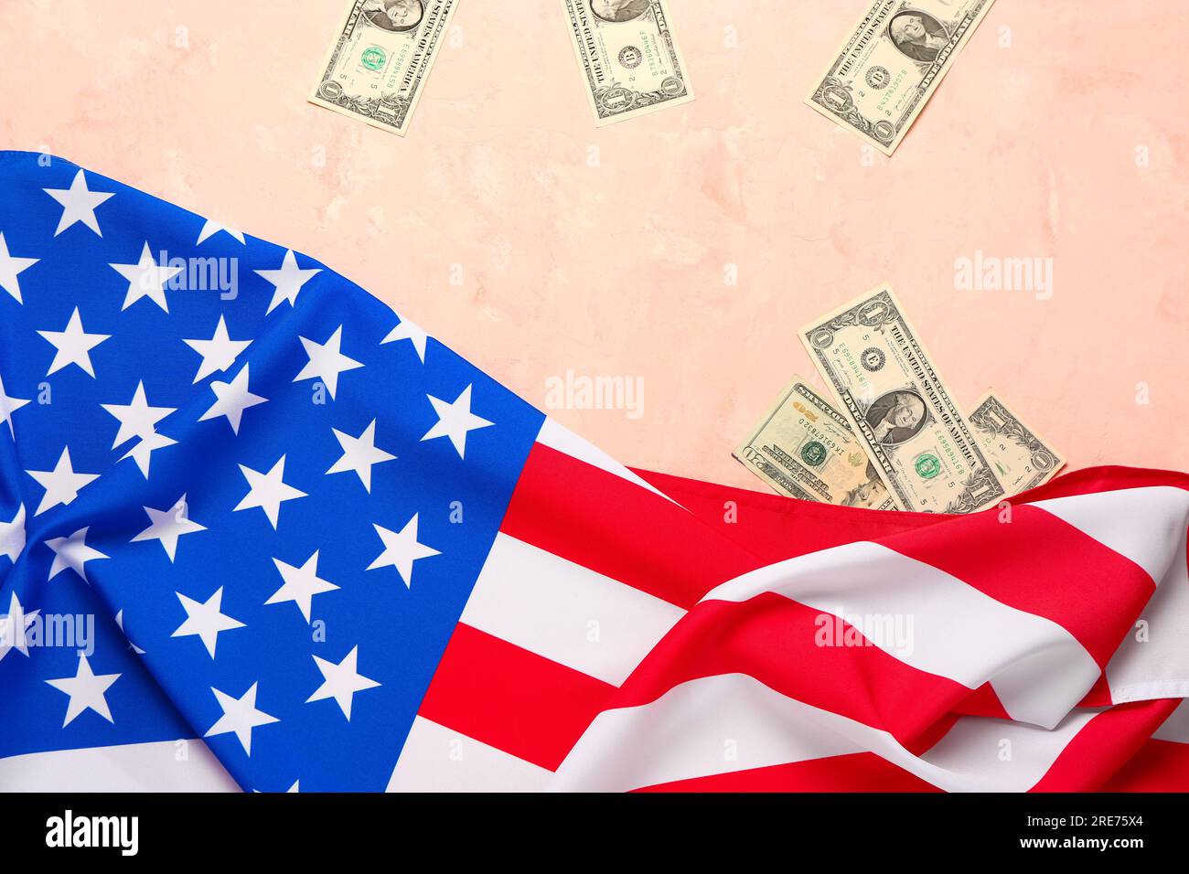 Flag of USA and dollar banknotes on beige background Stock Photo - Alamy