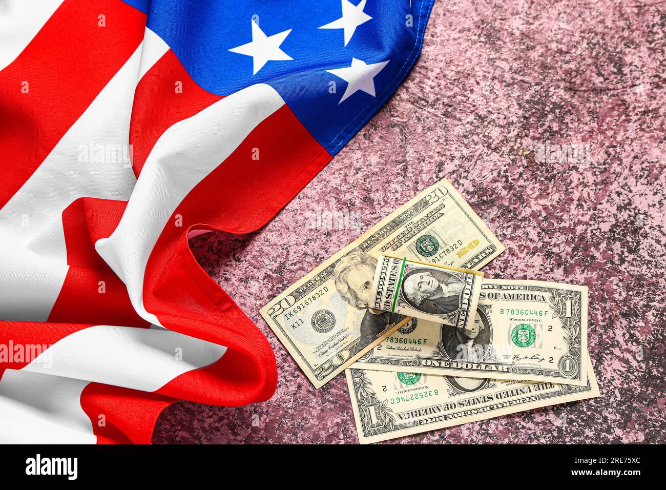 Flag of USA and dollar banknotes on purple background Stock Photo - Alamy