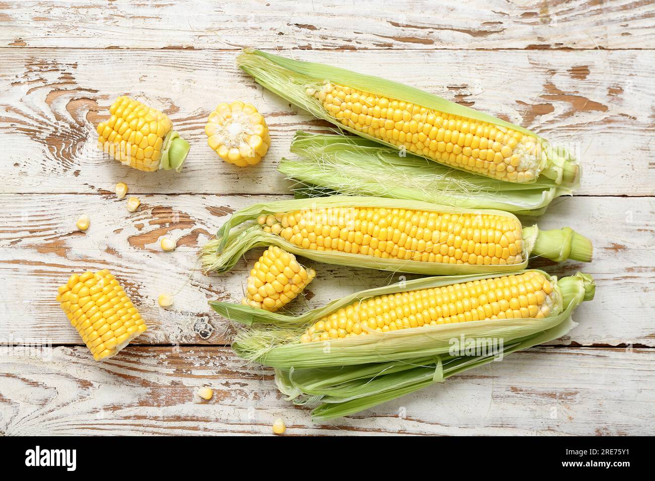 Fresh corn cobs on weathered wooden table Stock Photo - Alamy