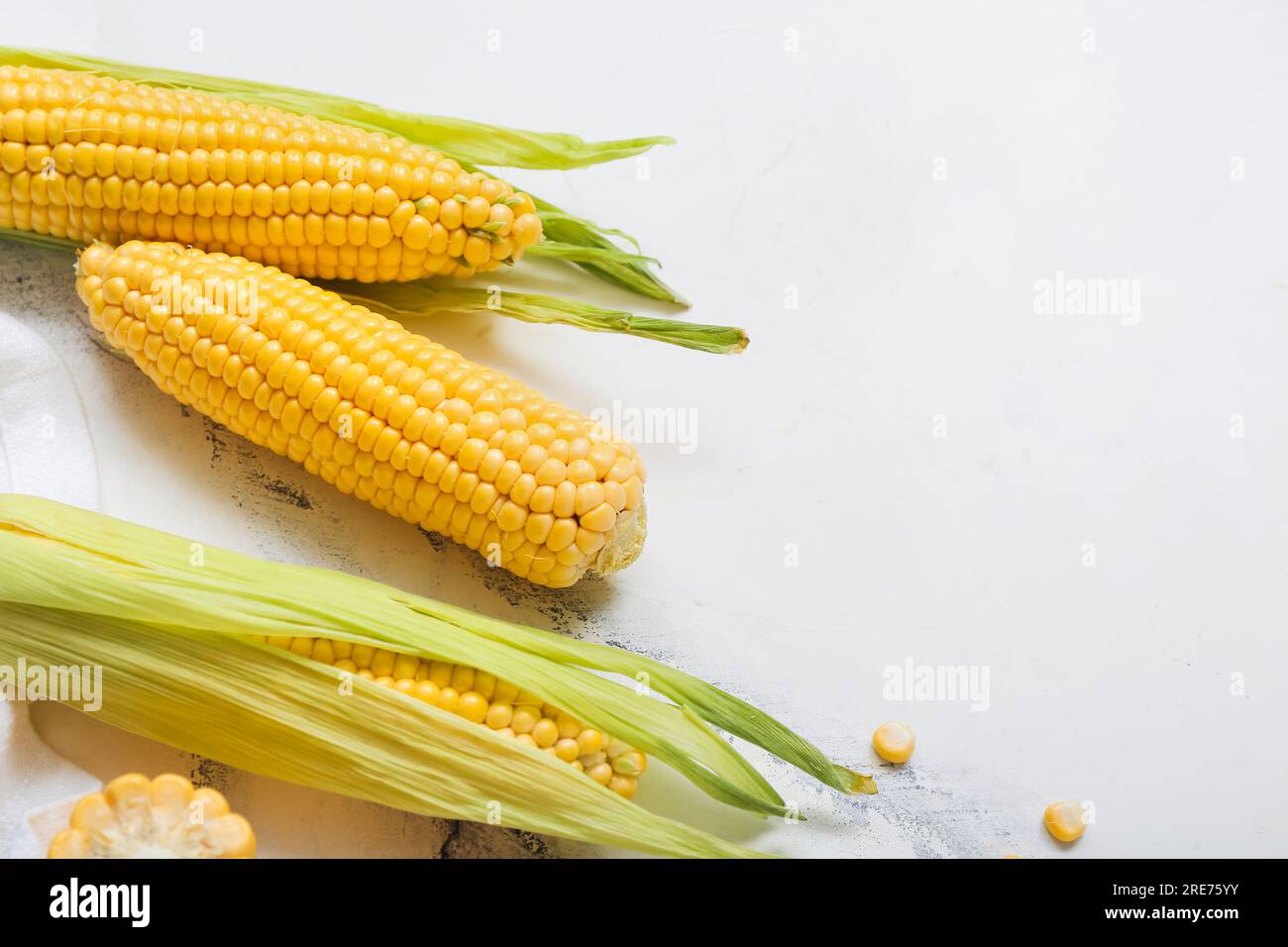 Fresh corn cobs on white marble table Stock Photo - Alamy
