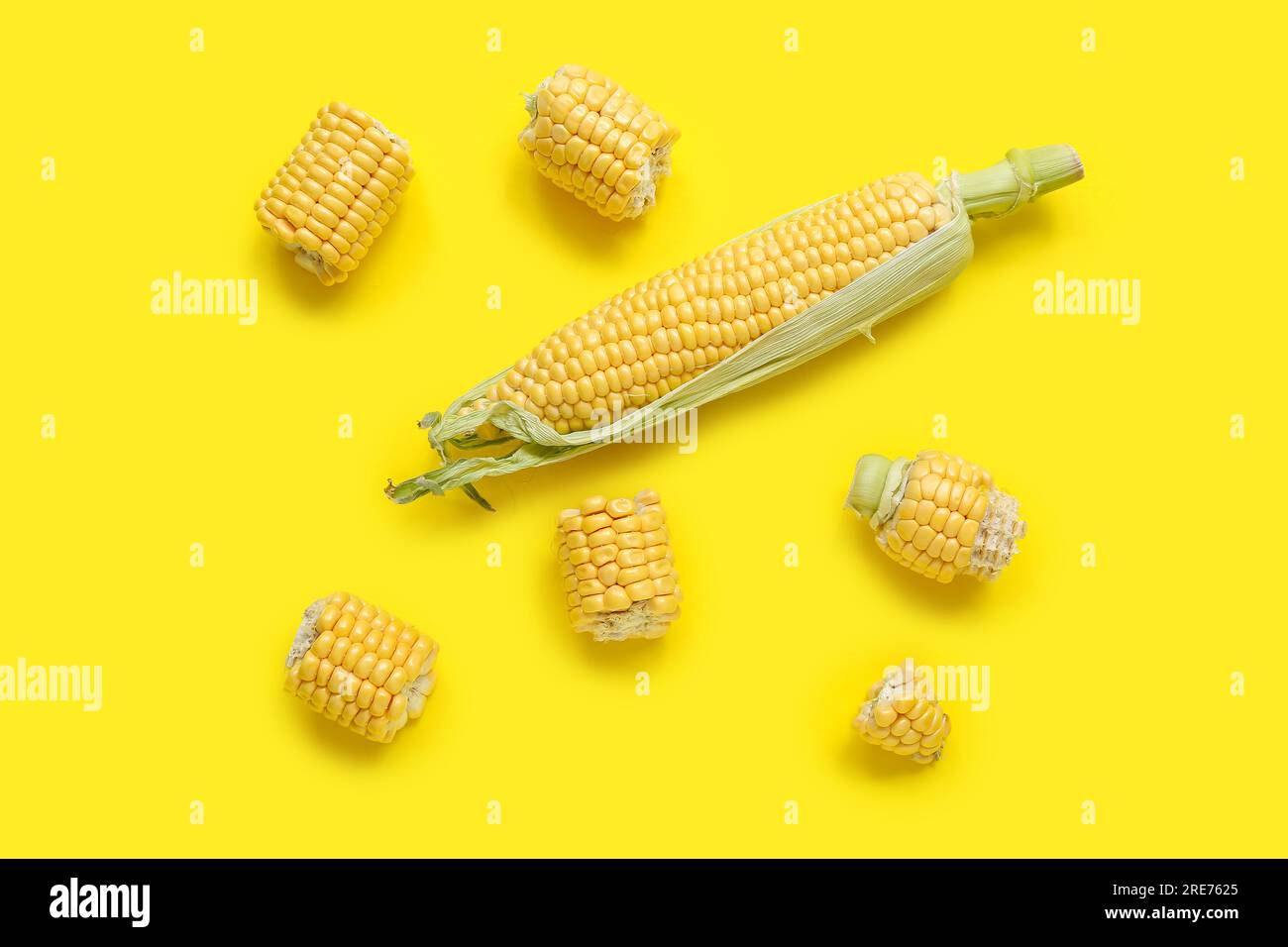 Cut and whole corn cobs on yellow background Stock Photo - Alamy