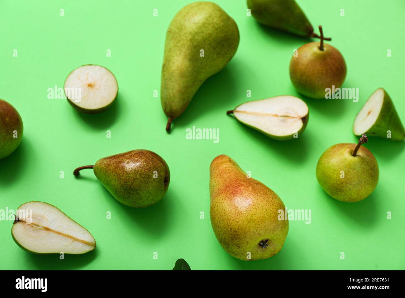 Different types of ripe pears on green background Stock Photo - Alamy