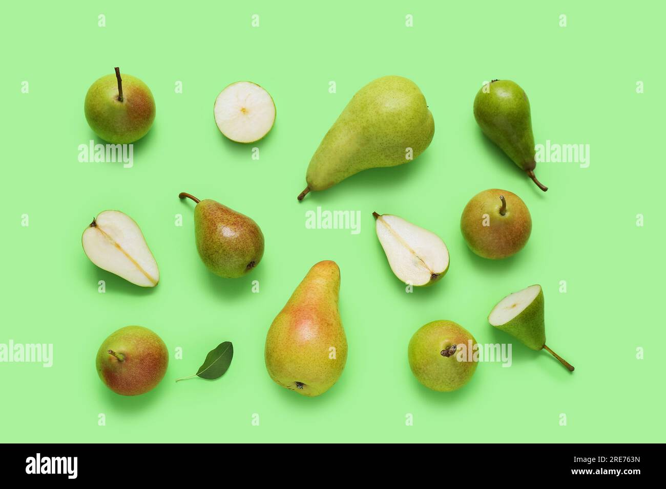 Different types of ripe pears on green background Stock Photo - Alamy