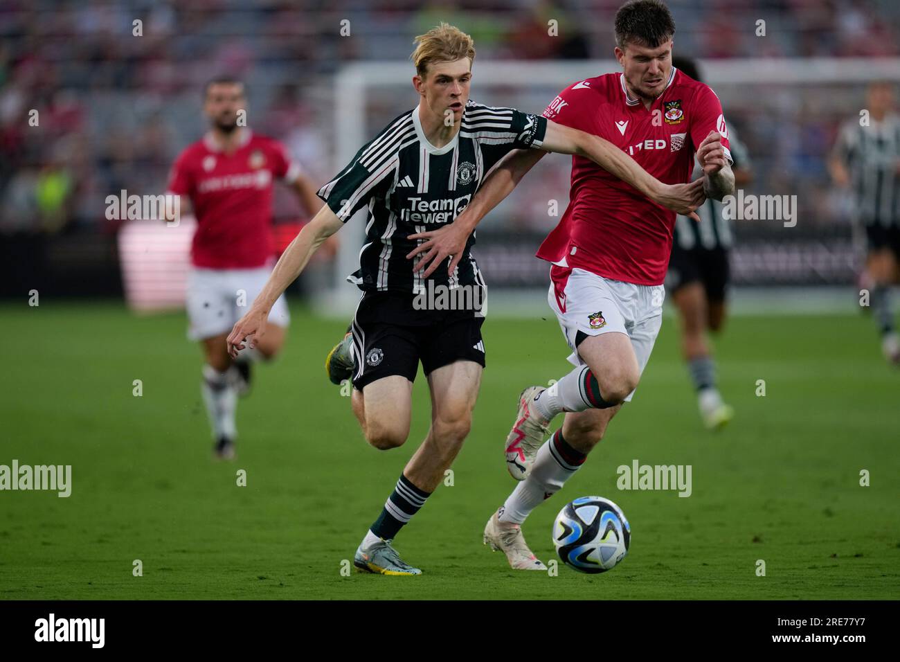 Manchester United midfielder Toby Collyer, left, battles Wrexham ...