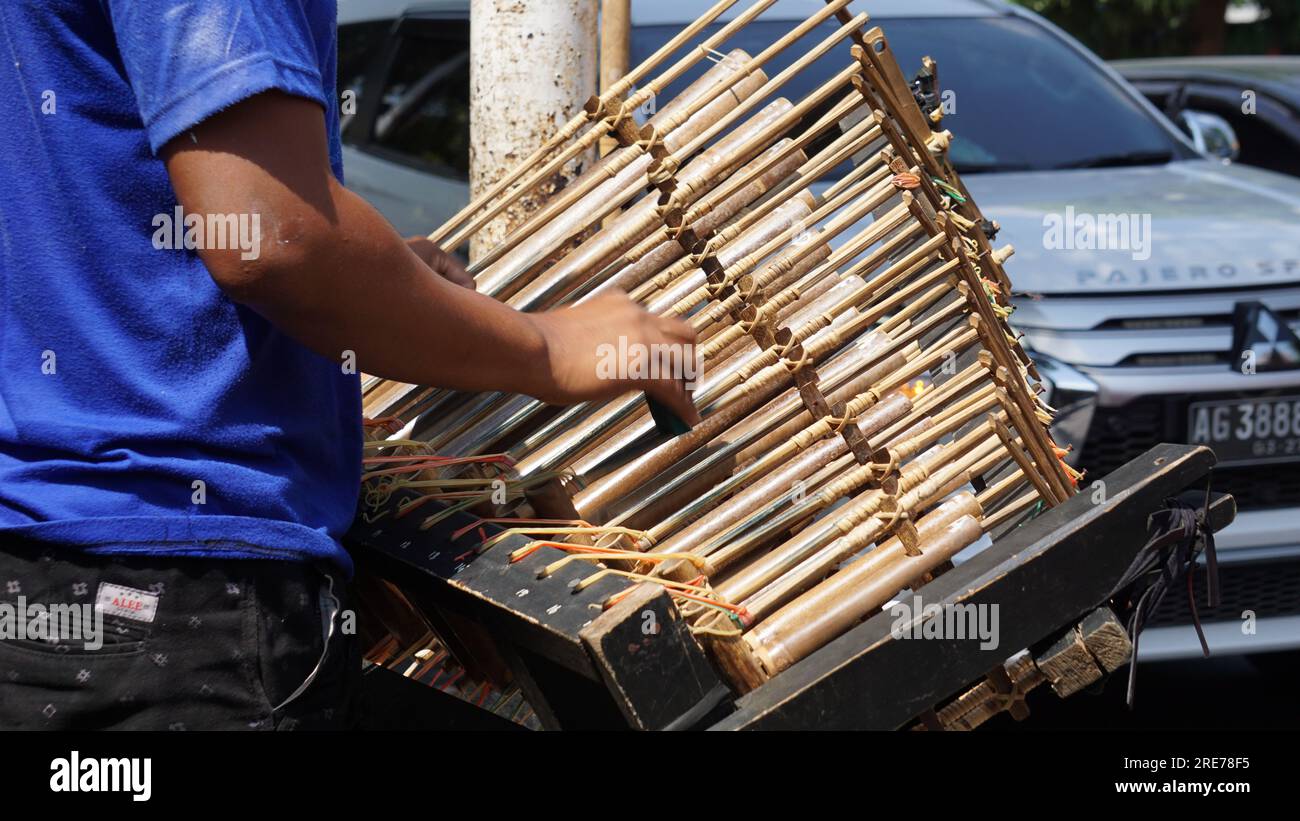 Man playing angklung multitonal hi-res stock photography and images - Alamy