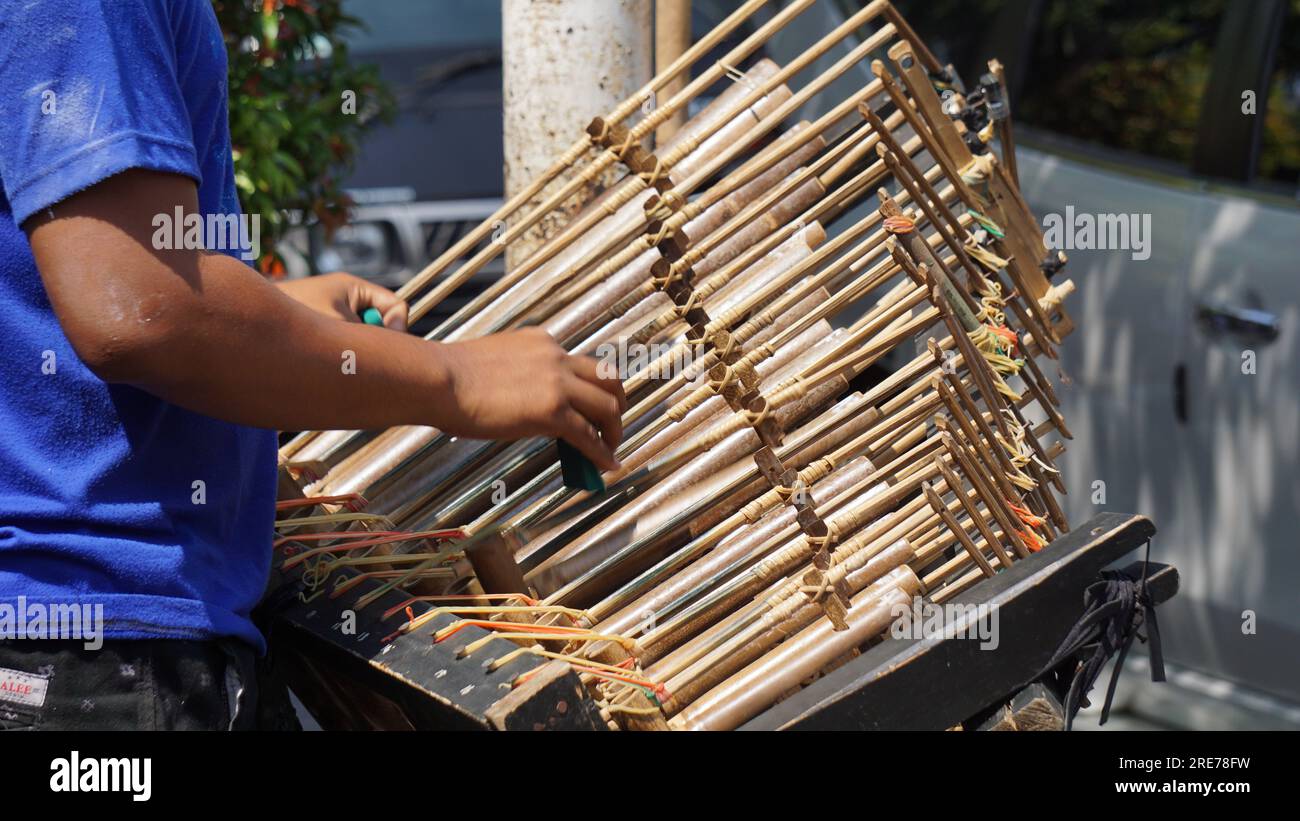 Man playing angklung multitonal hi-res stock photography and images - Alamy