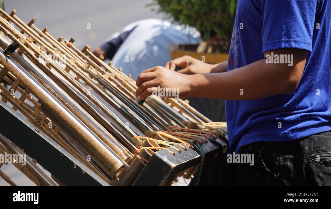 Man playing angklung multitonal hi-res stock photography and images - Alamy