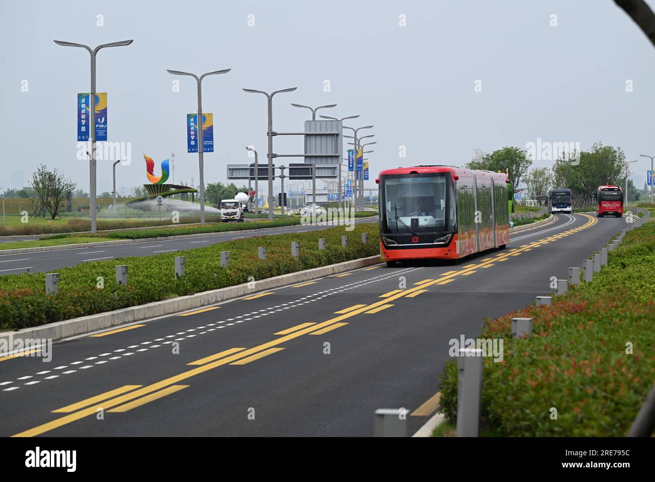 Two autonomous rail buses travel on the road in Chengdu City, southwest ...