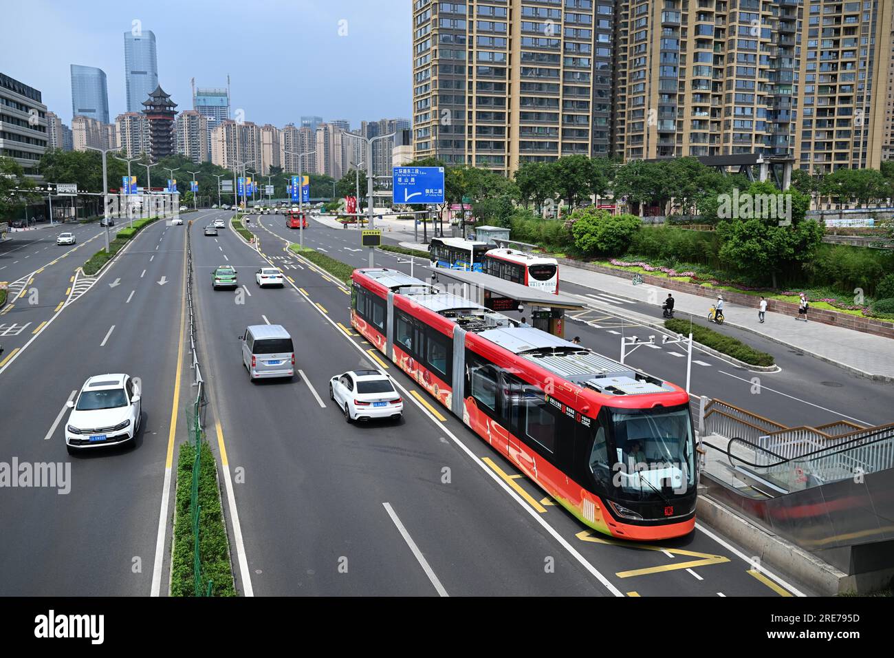 Two autonomous rail buses travel on the road in Chengdu City, southwest ...