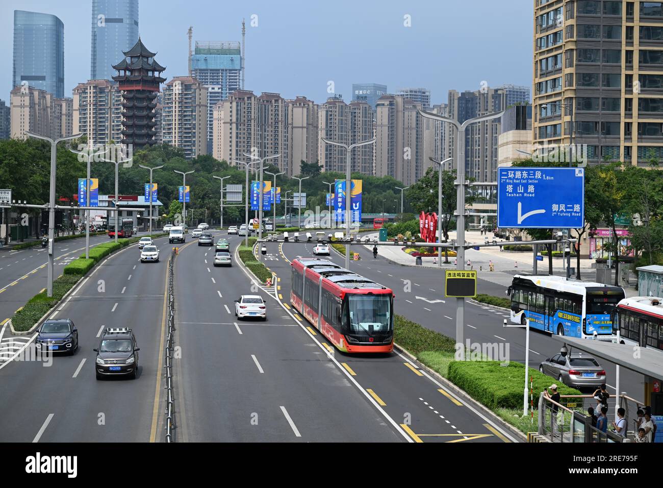 Two autonomous rail buses travel on the road in Chengdu City, southwest ...
