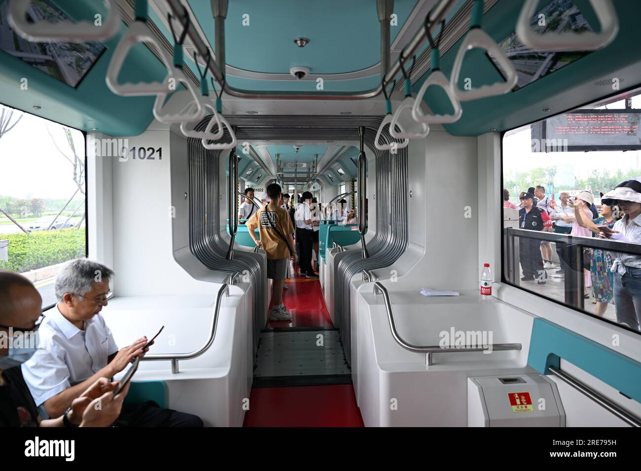 Two autonomous rail buses travel on the road in Chengdu City, southwest ...