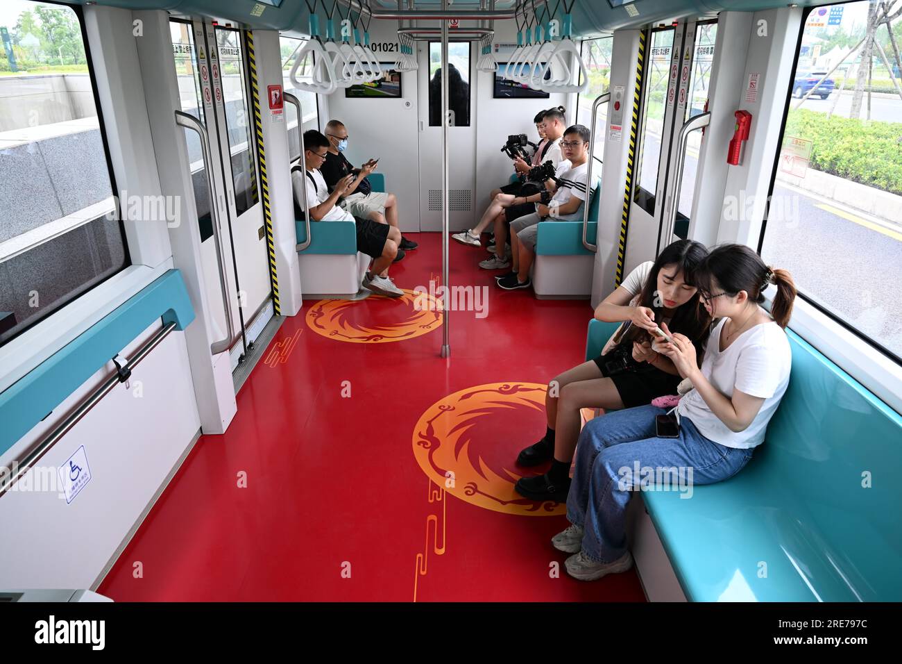 Two autonomous rail buses travel on the road in Chengdu City, southwest ...