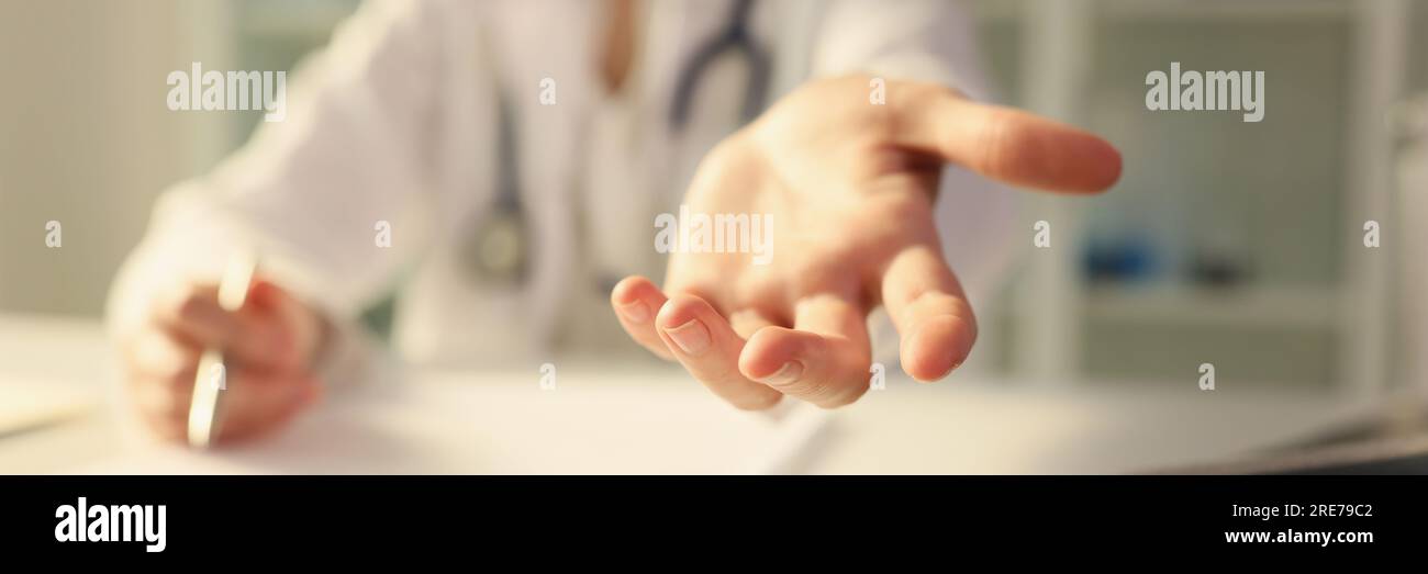 Doctor extending helping hand to patient in clinic closeup Stock Photo ...