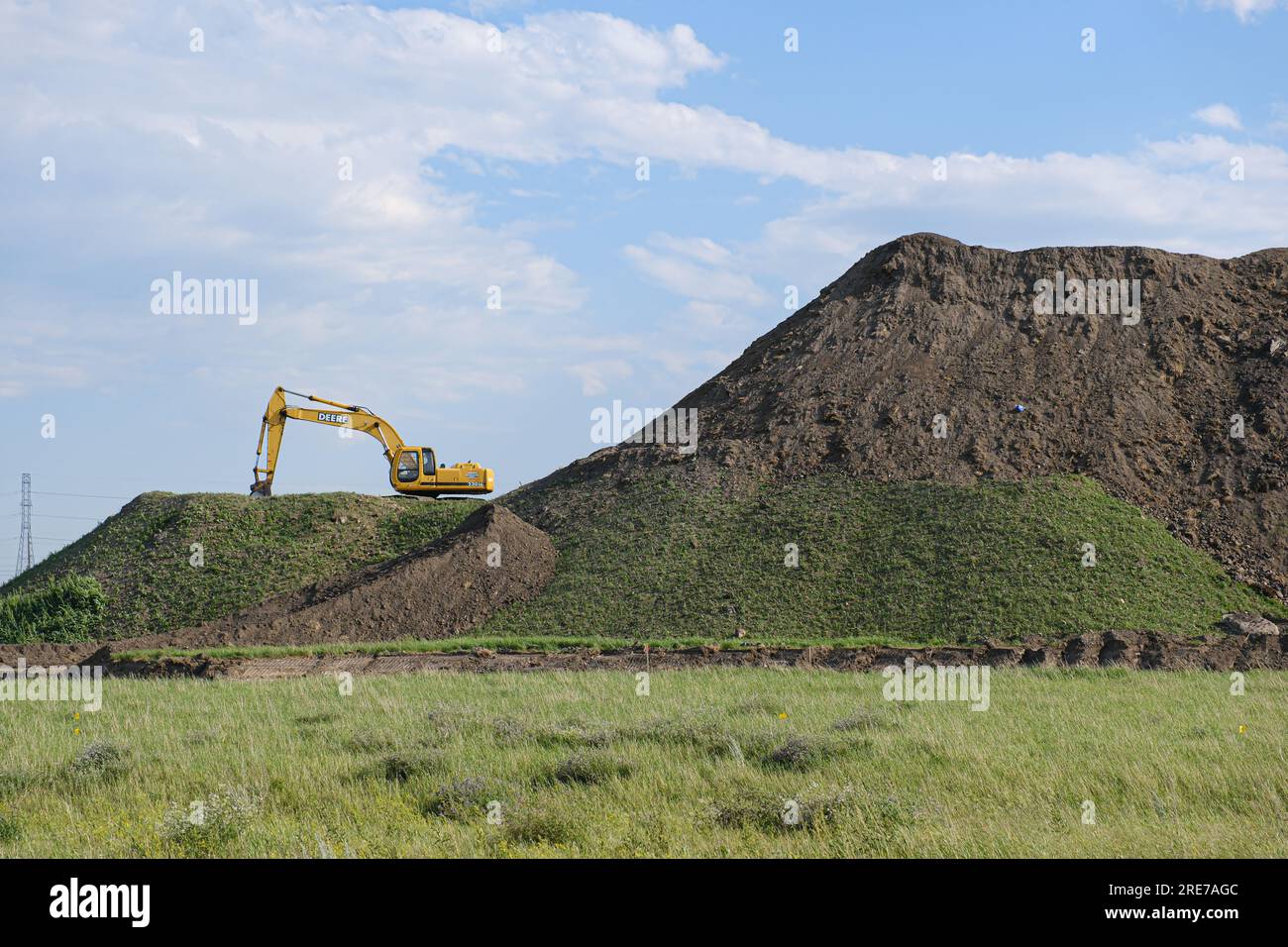 27 July 2023 - Calgary Alberta Canada - Excavator tractor on pile of ...