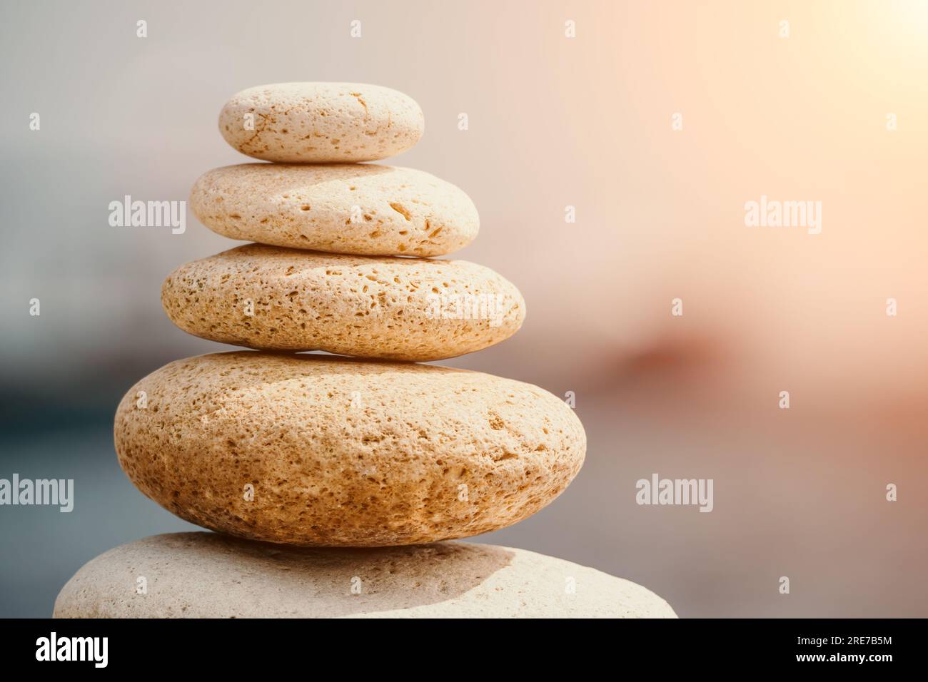 balanced rock pyramid on the pebbled beach is a study in harmony and ...