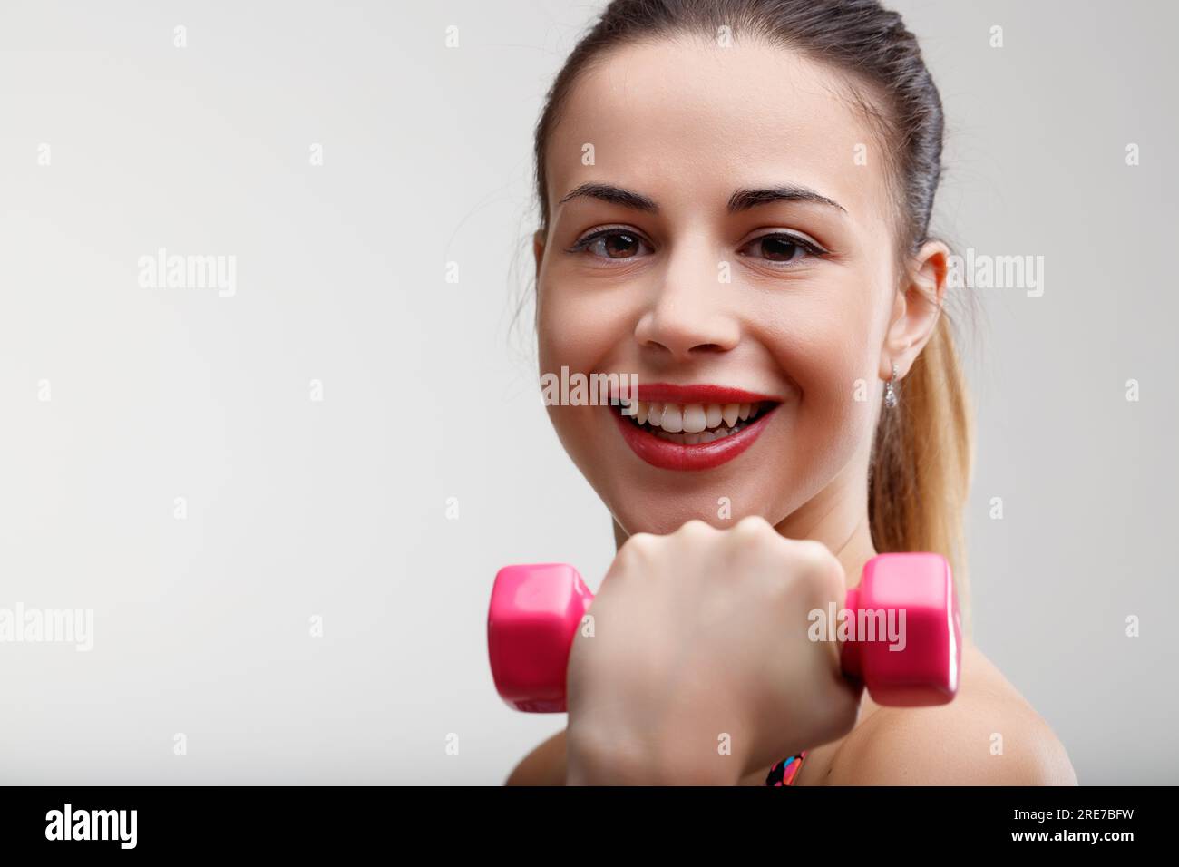 Foreground shows blurred weight, background features a woman working ...
