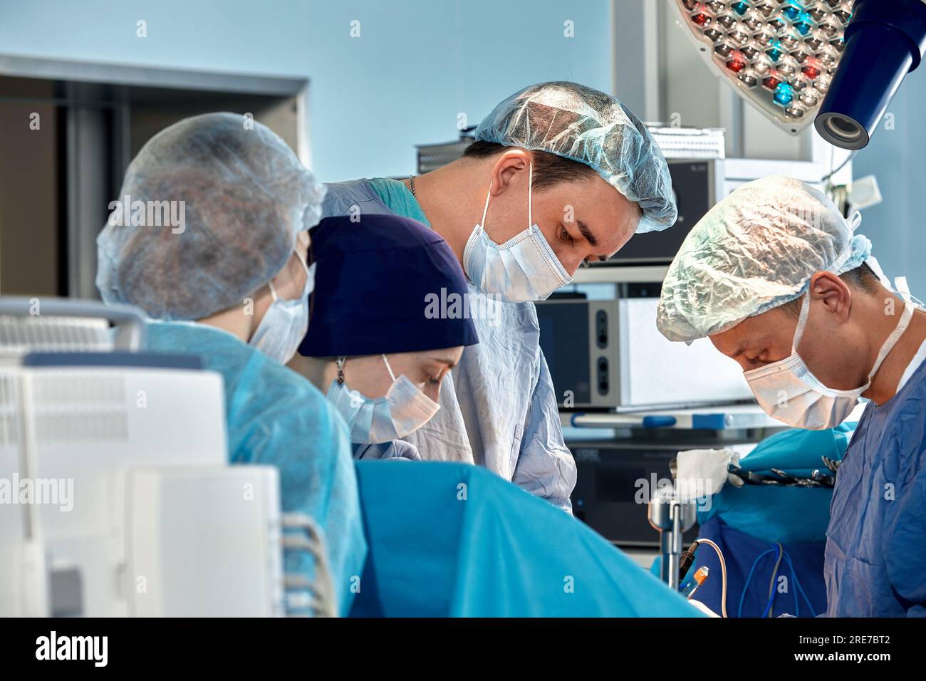 Surgeons team during complex surgical operation in a sterile operating ...