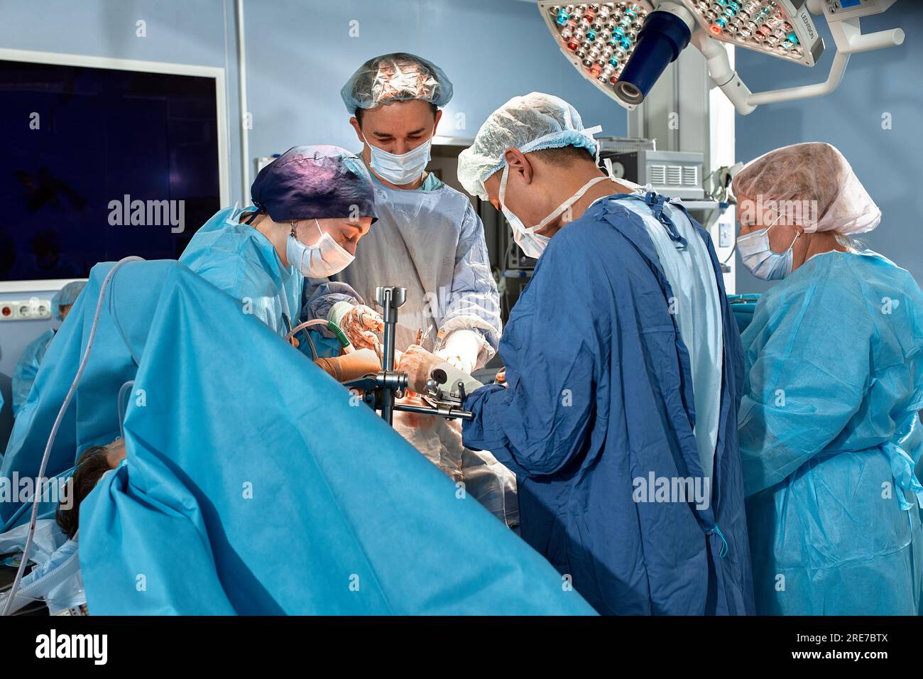 Surgeons team during complex surgical operation in a sterile operating ...