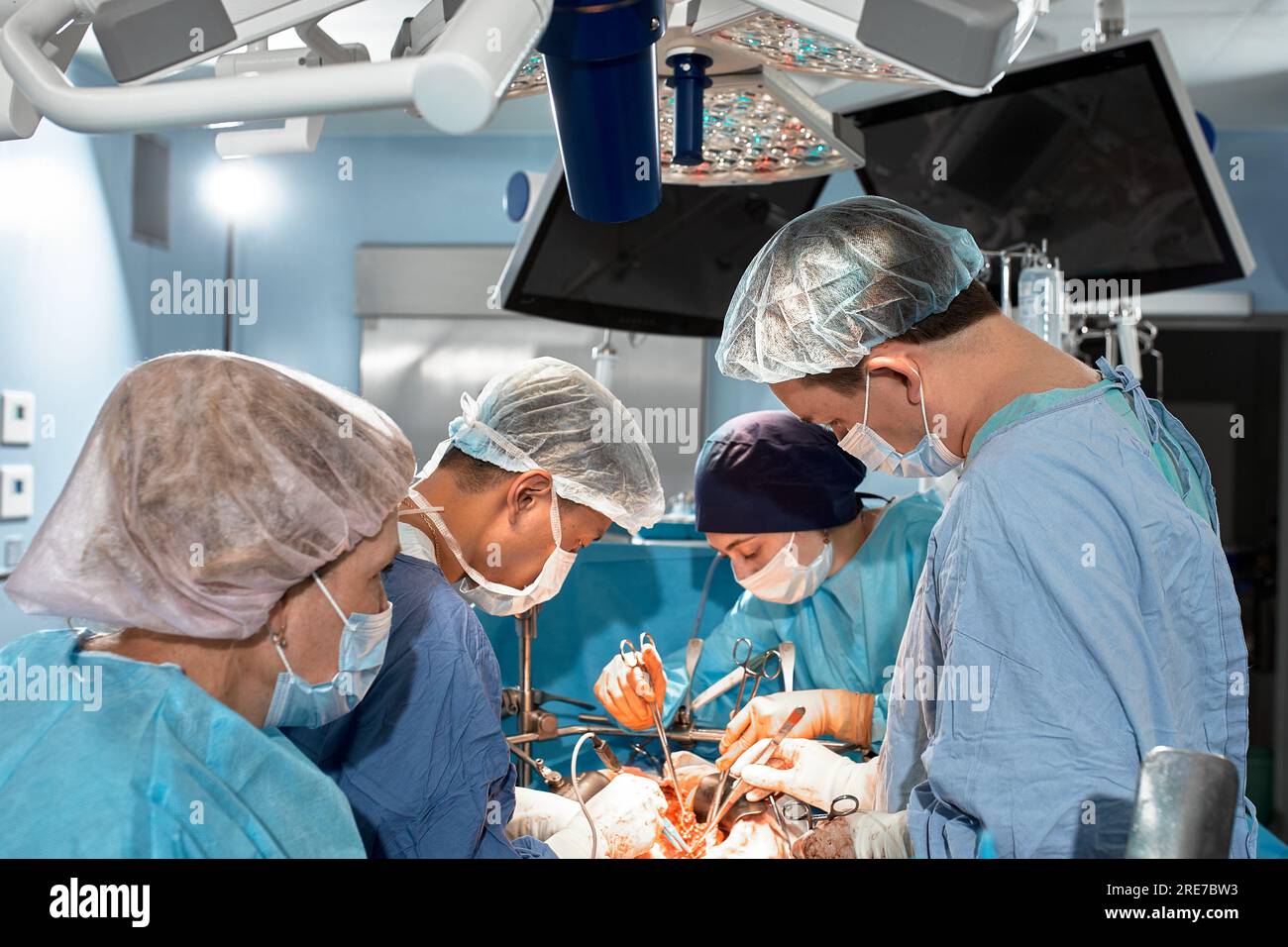 Surgeons team during complex surgical operation in a sterile operating ...