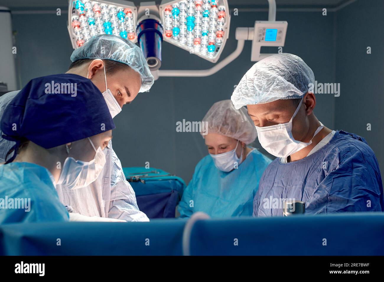 Surgeons team during complex surgical operation in a sterile operating ...
