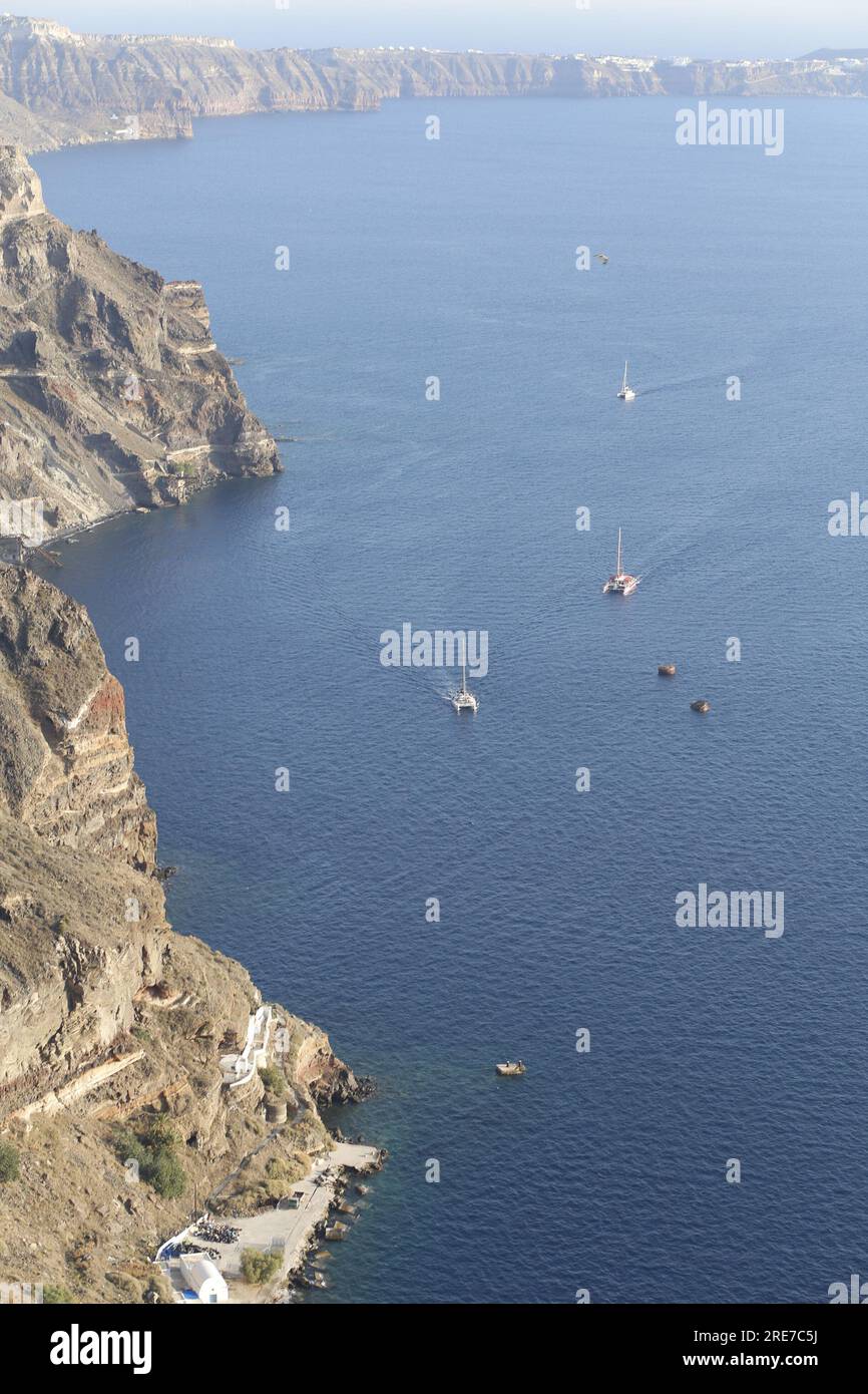 Cruisers and boats sailing in the shore waters of Santorini, Greek ...