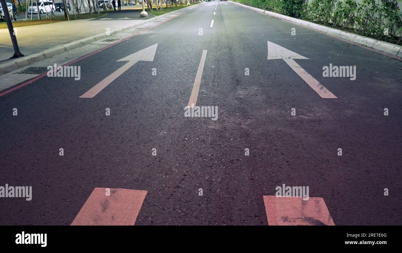 Two white arrows on the road. Arrow sign on the asphalt. relentless ...