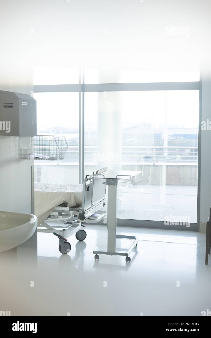 View through door window of patient room with bed and medical equipment ...