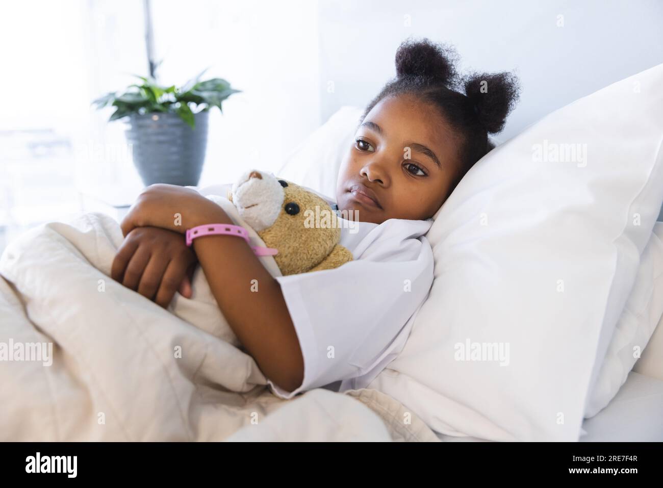 Sad african lying in hospital bed hi-res stock photography and images ...