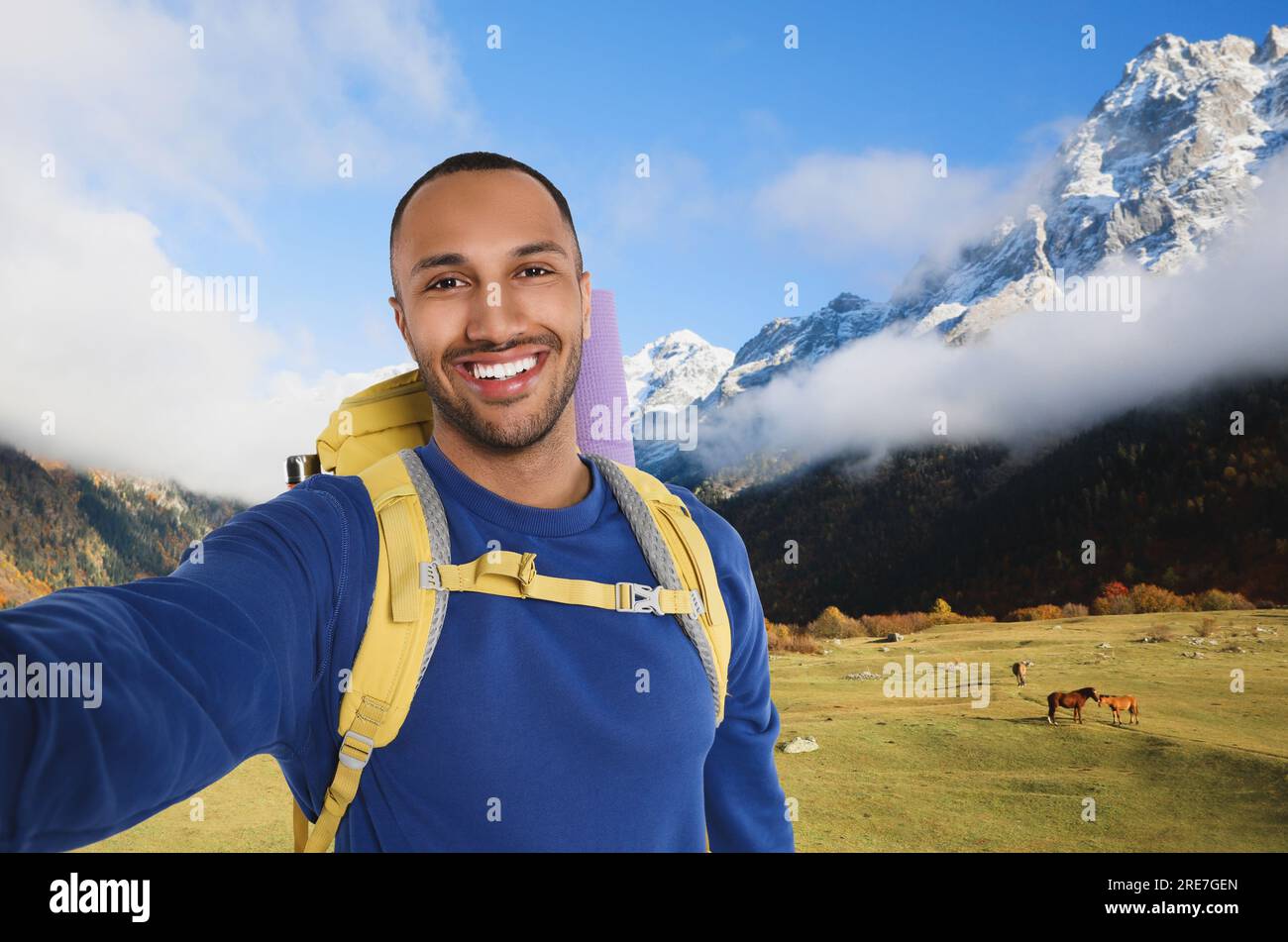 Happy tourist with backpack taking selfie in mountains Stock Photo - Alamy