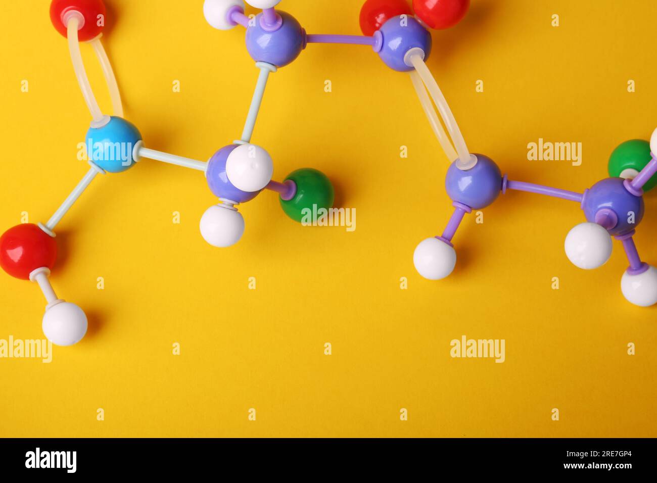 Structure of molecule on yellow background, top view. Chemical model ...