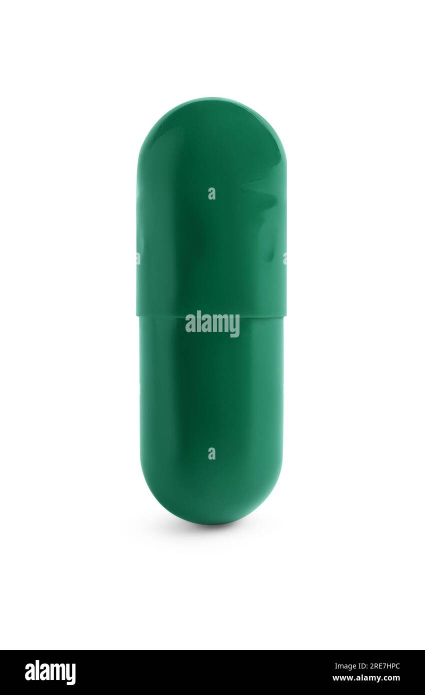 One green pill on white background. Medicinal treatment Stock Photo - Alamy