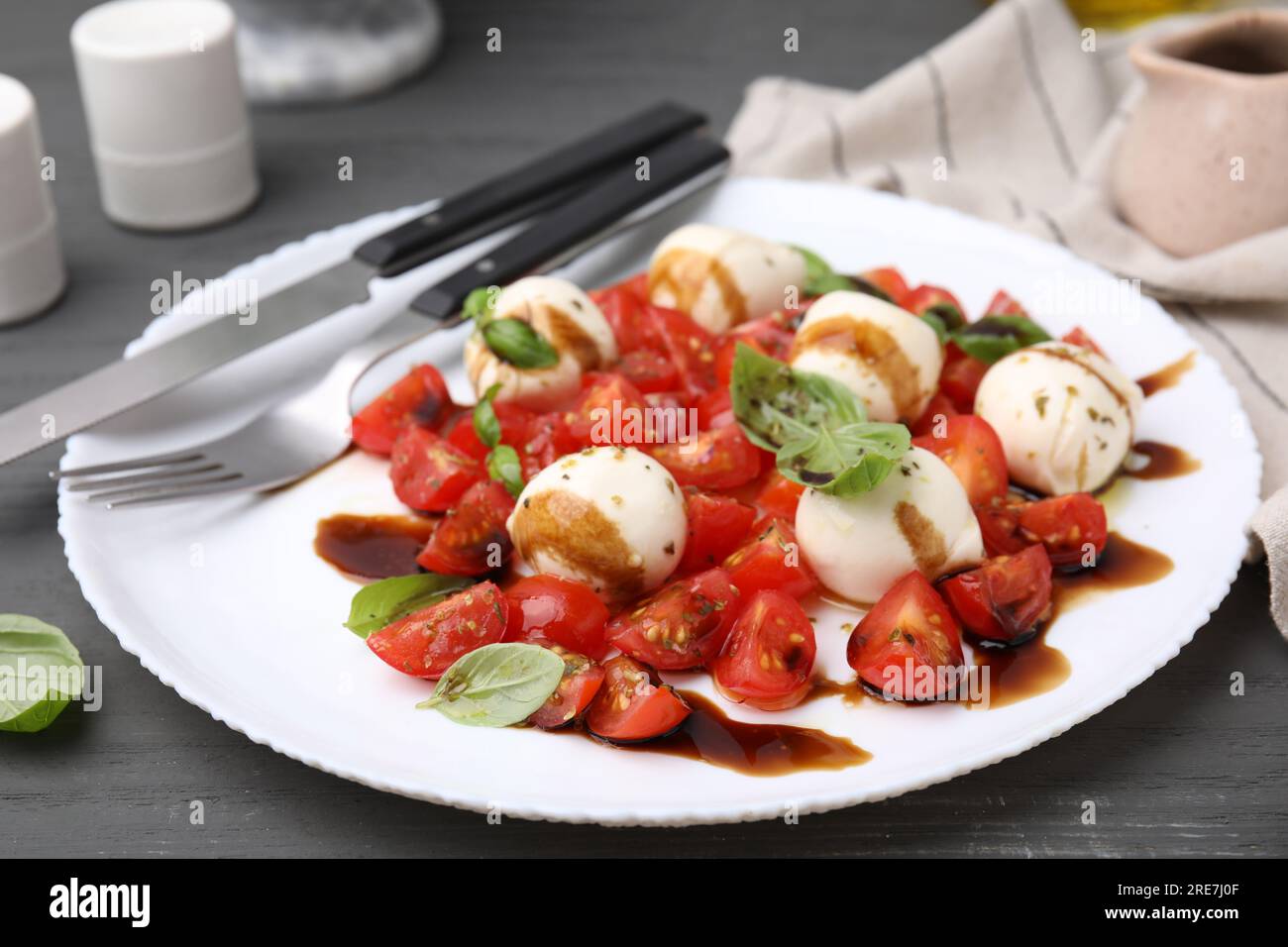 Tasty salad Caprese with tomatoes, mozzarella balls, basil and balsamic ...