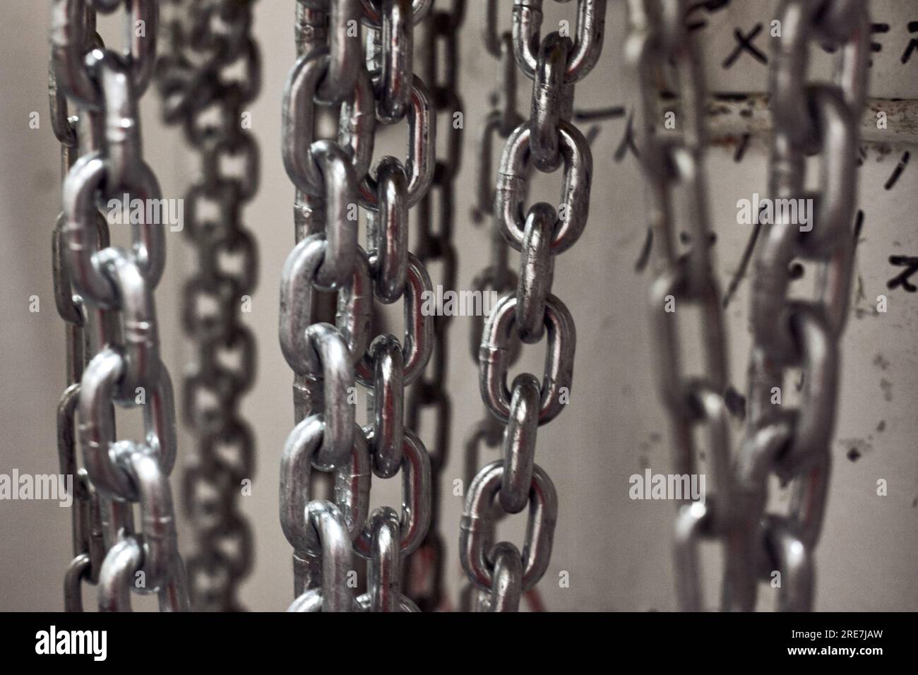Multiple lines of Steel chains hanging Stock Photo - Alamy