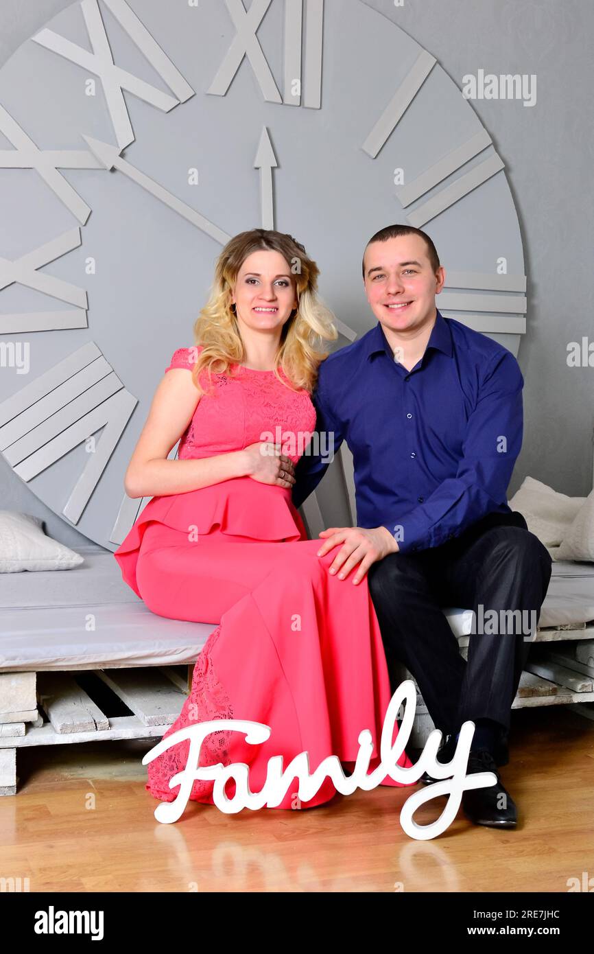 Attractive young couple is celebrating holiday at home. Standing on the ...